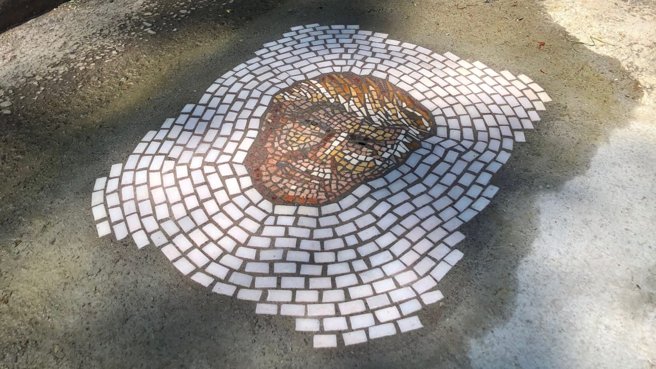This artist quietly fixed a pothole with a mosaic of Trump’s face