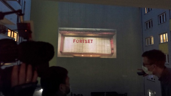 Berlin residents watch films projected on building exteriors